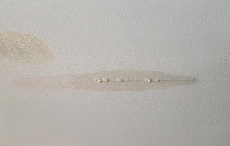 Water Leaking From Ceiling? (What It Means & How To Fix It)